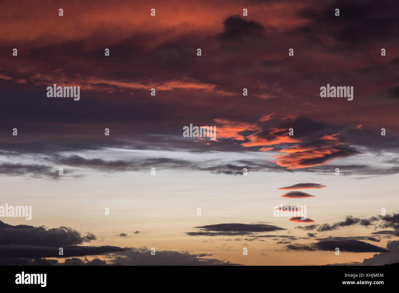 Beautiful red clouds at sunset, making abstract shapes Stock Photo - Alamy