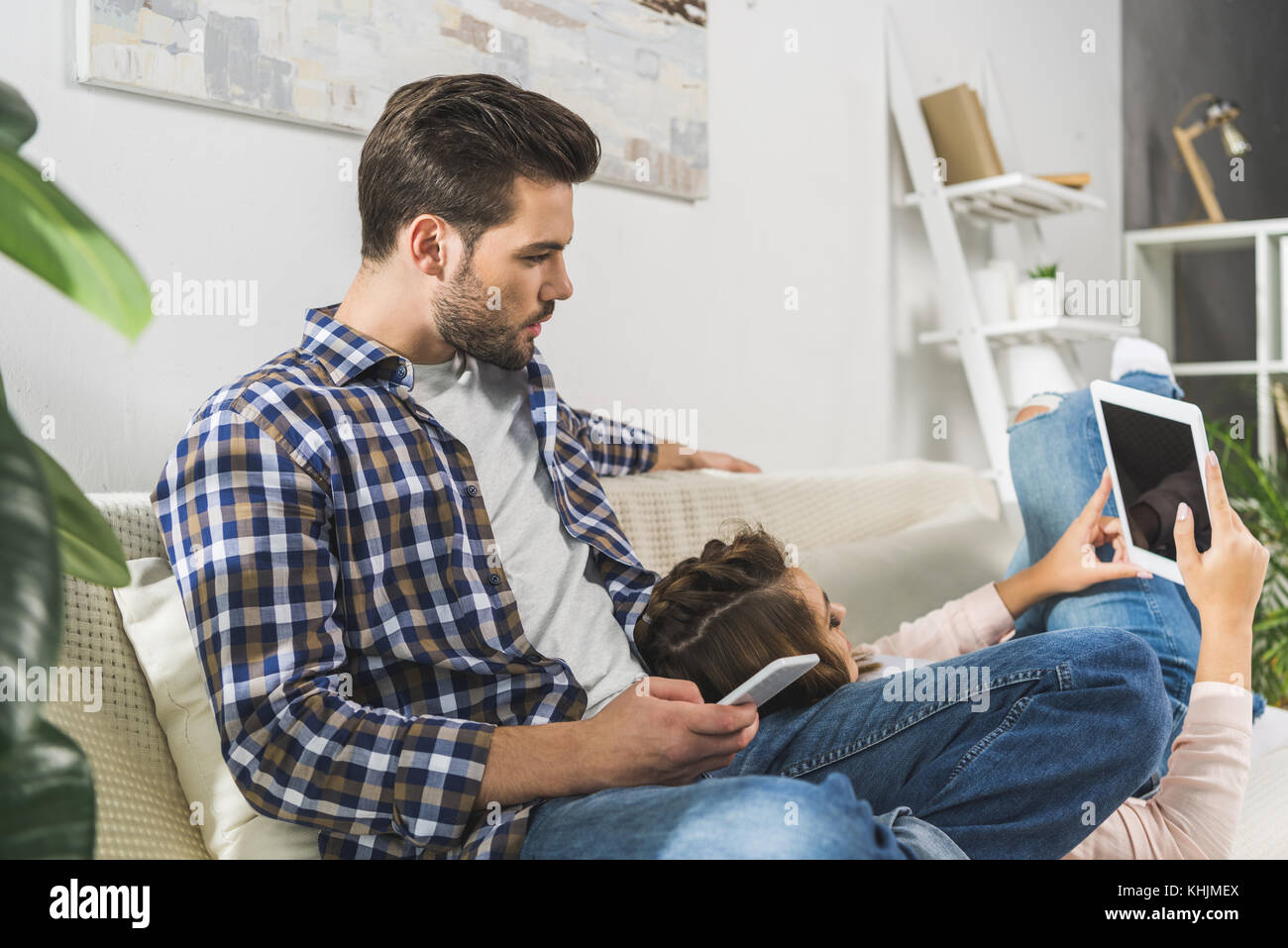 attractive couple using devices Stock Photo - Alamy