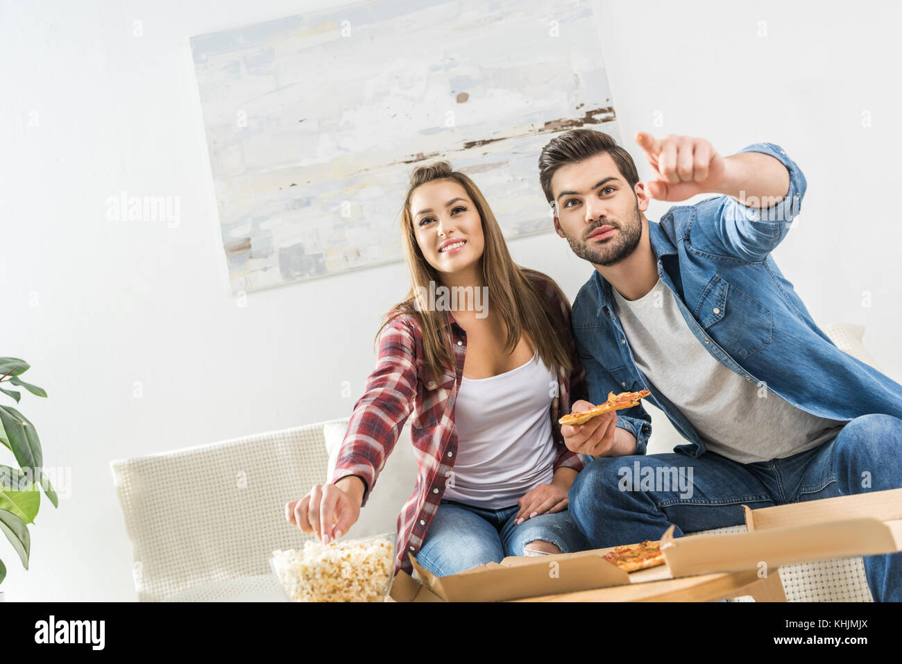 couple watching tv with snacks Stock Photo - Alamy