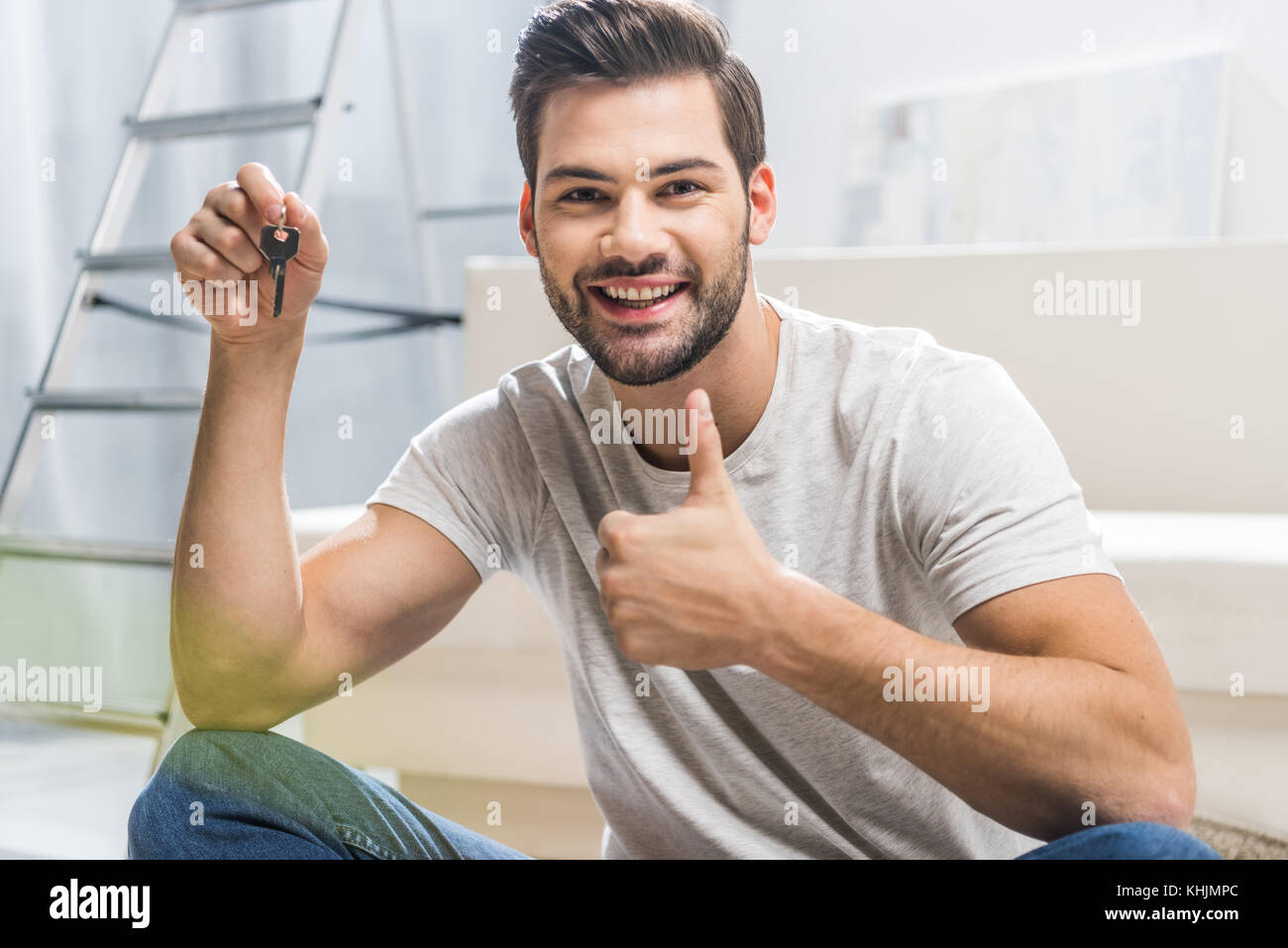 Happy man showing key Stock Photo - Alamy