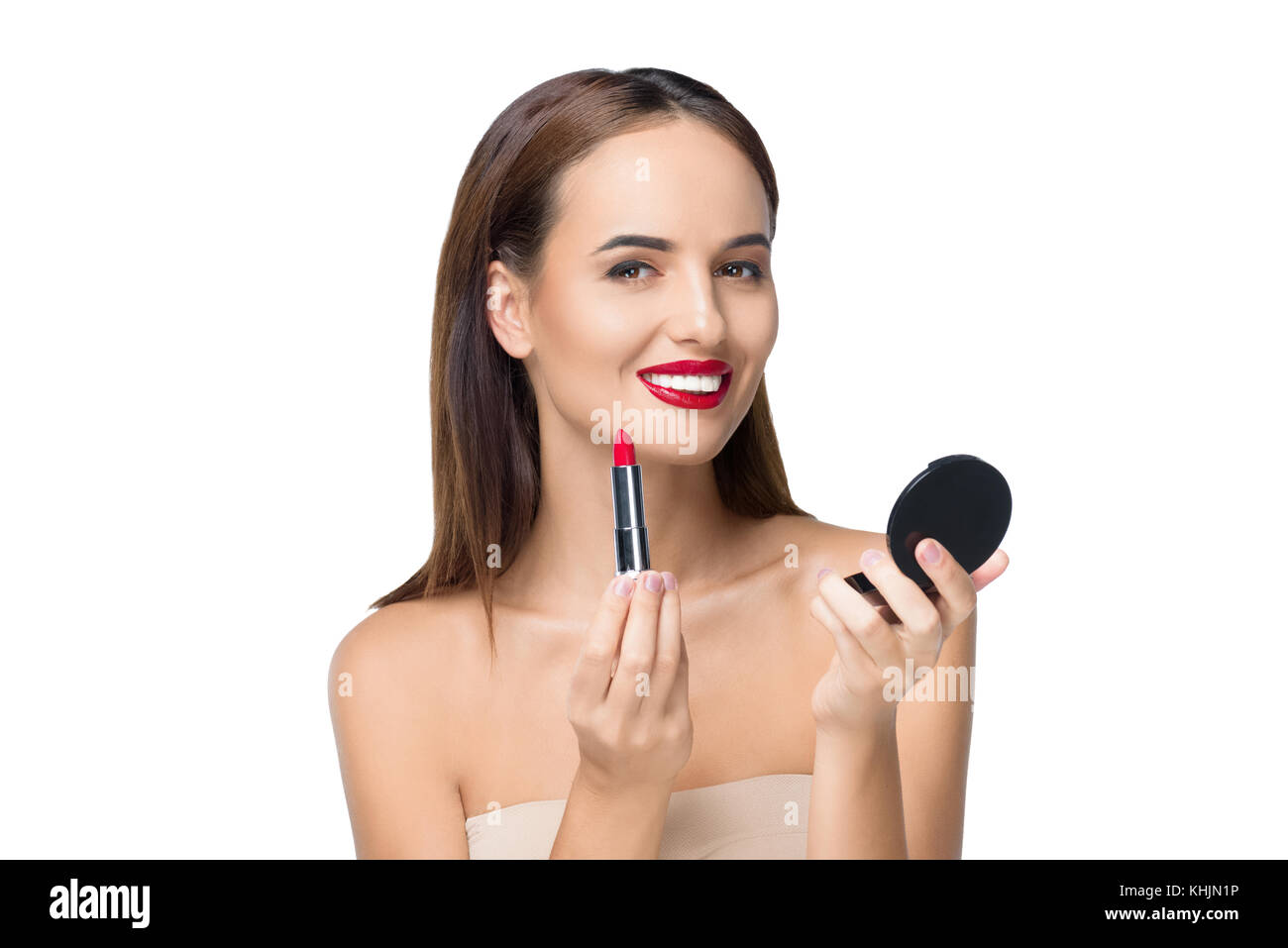 young woman applying makeup Stock Photo - Alamy