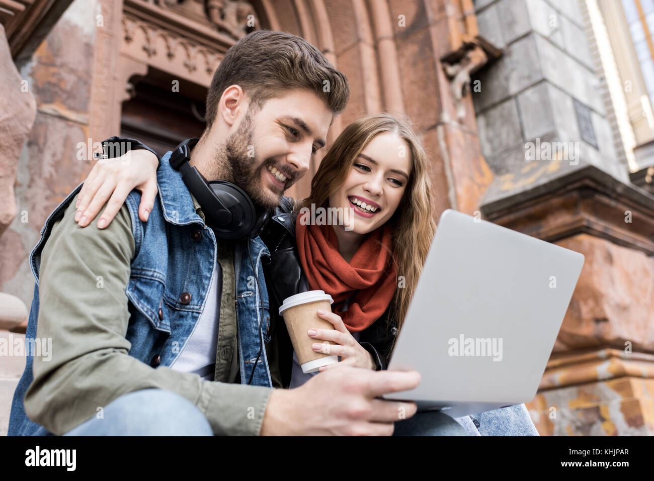 couple using laptop on street Stock Photo - Alamy