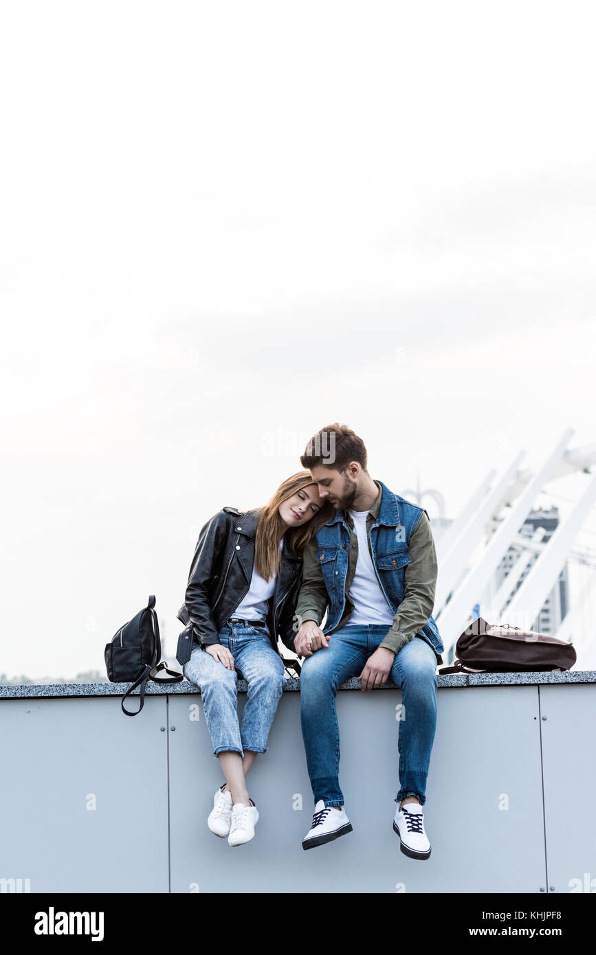 couple resting on parapet Stock Photo - Alamy