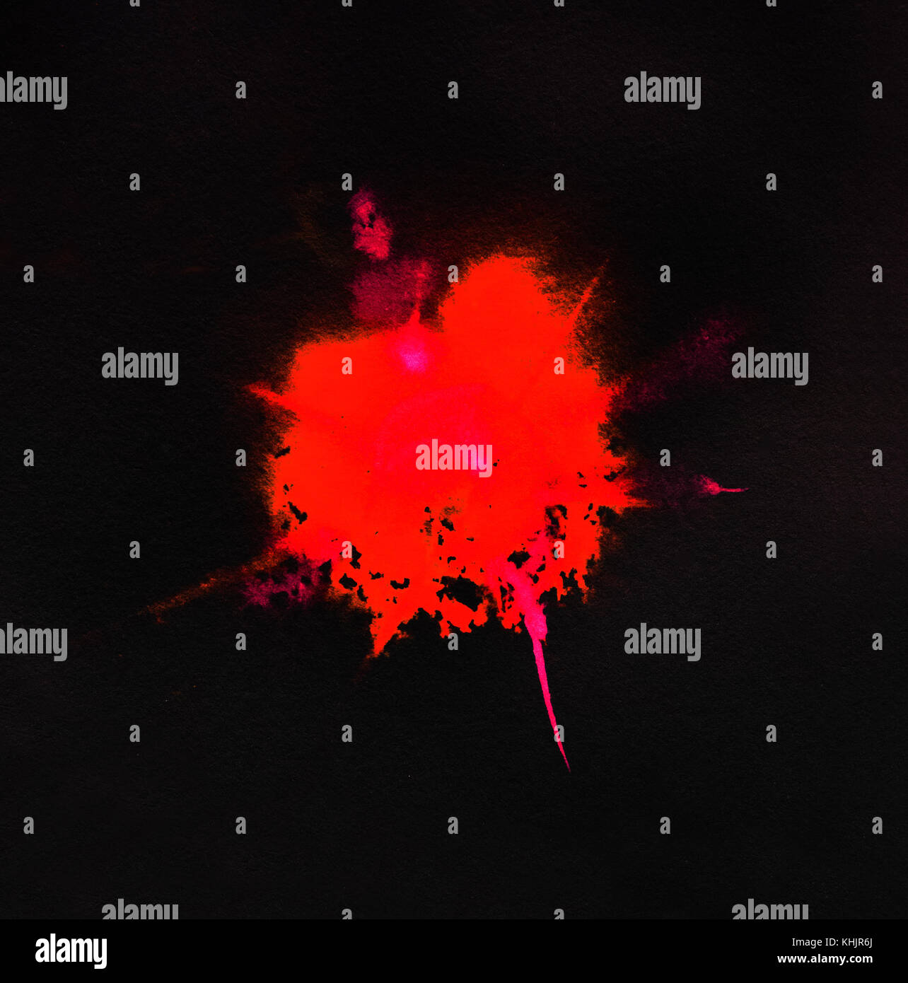 Watercolor red color splash on black background Stock Photo - Alamy