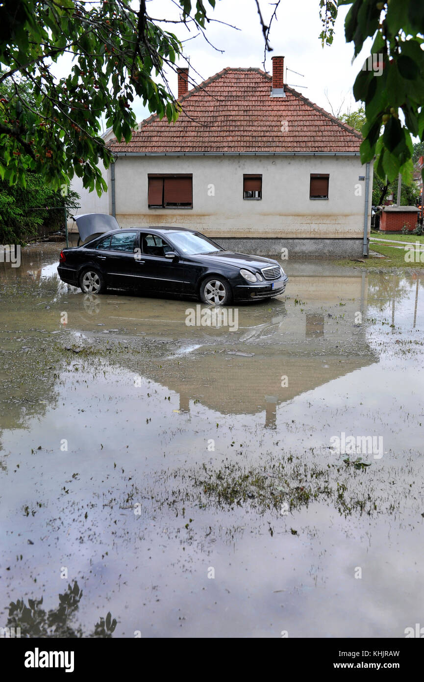 The consequences of flooding, car in front of flooded house Stock Photo ...