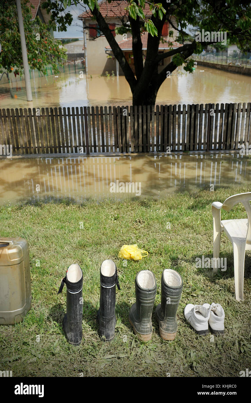 Concept photo of flooding. Waterproof rubber boots Stock Photo - Alamy