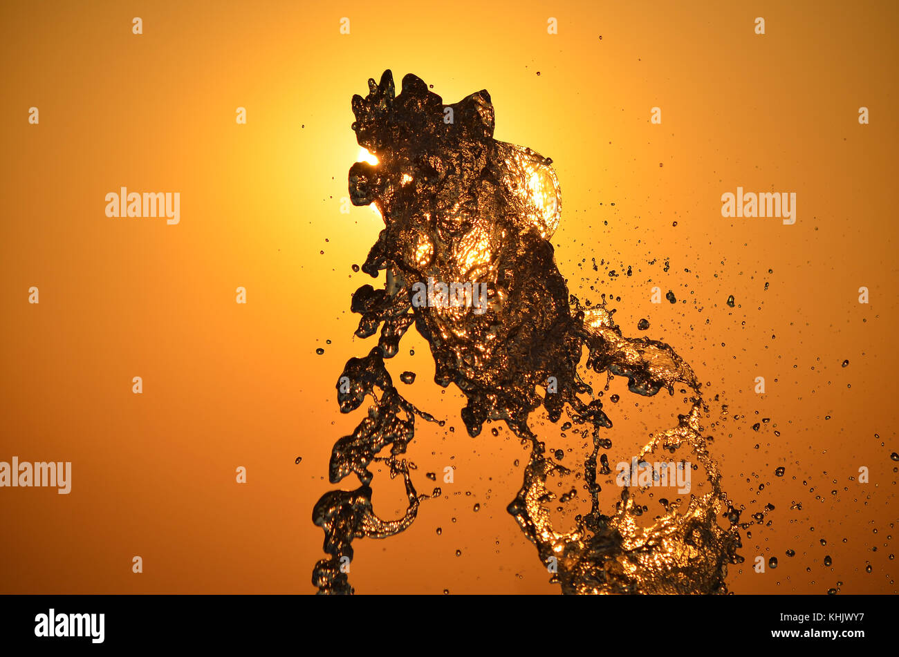 Water splash isolated on sunset colors background Stock Photo - Alamy