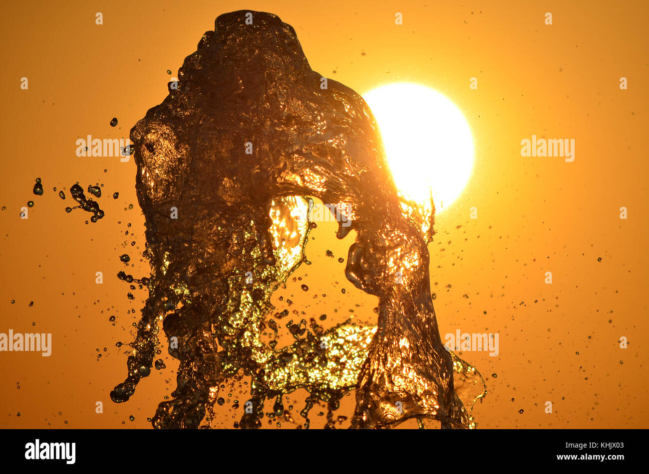 Water splash isolated on sunset colors background Stock Photo - Alamy
