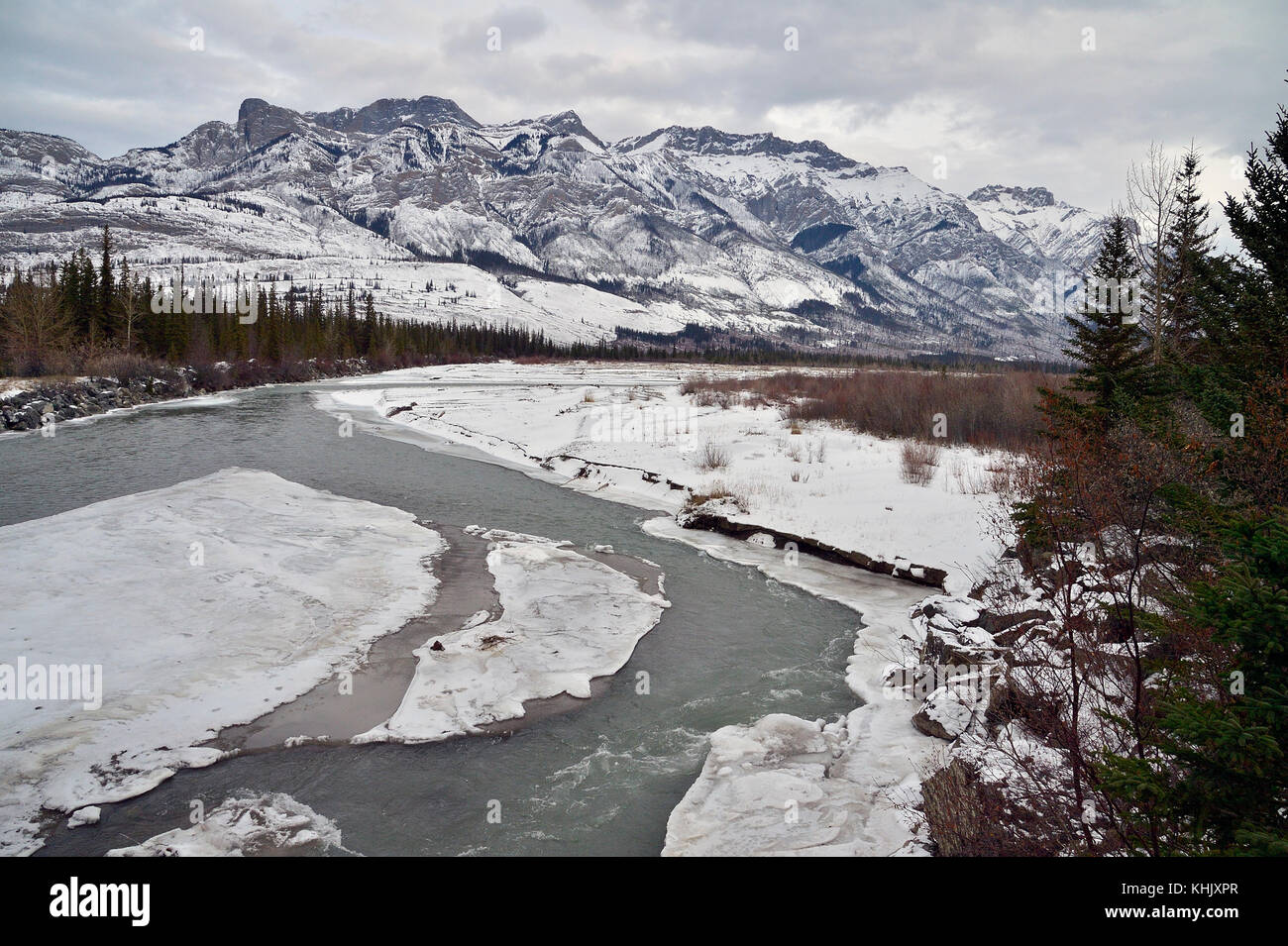 A winter landscape image of the Rocky river with the Miette mountain ...