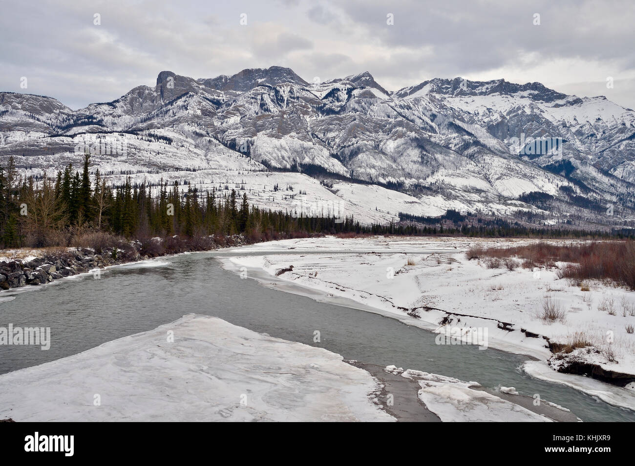 A landscape image of the Rocky river with the Miette mountain range in ...