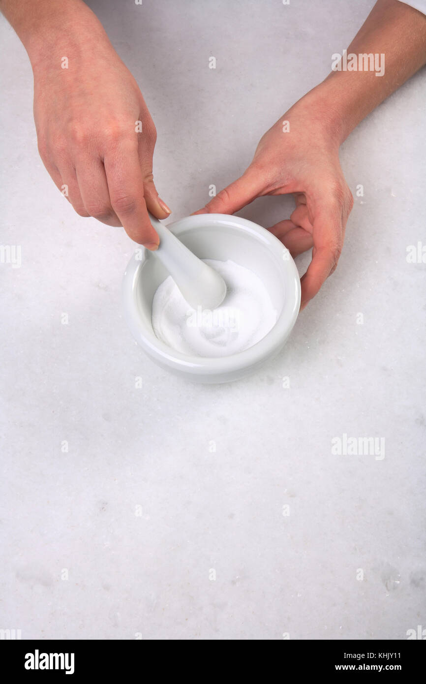 closeup of hands crushing powder on mortar with pestle Stock Photo - Alamy