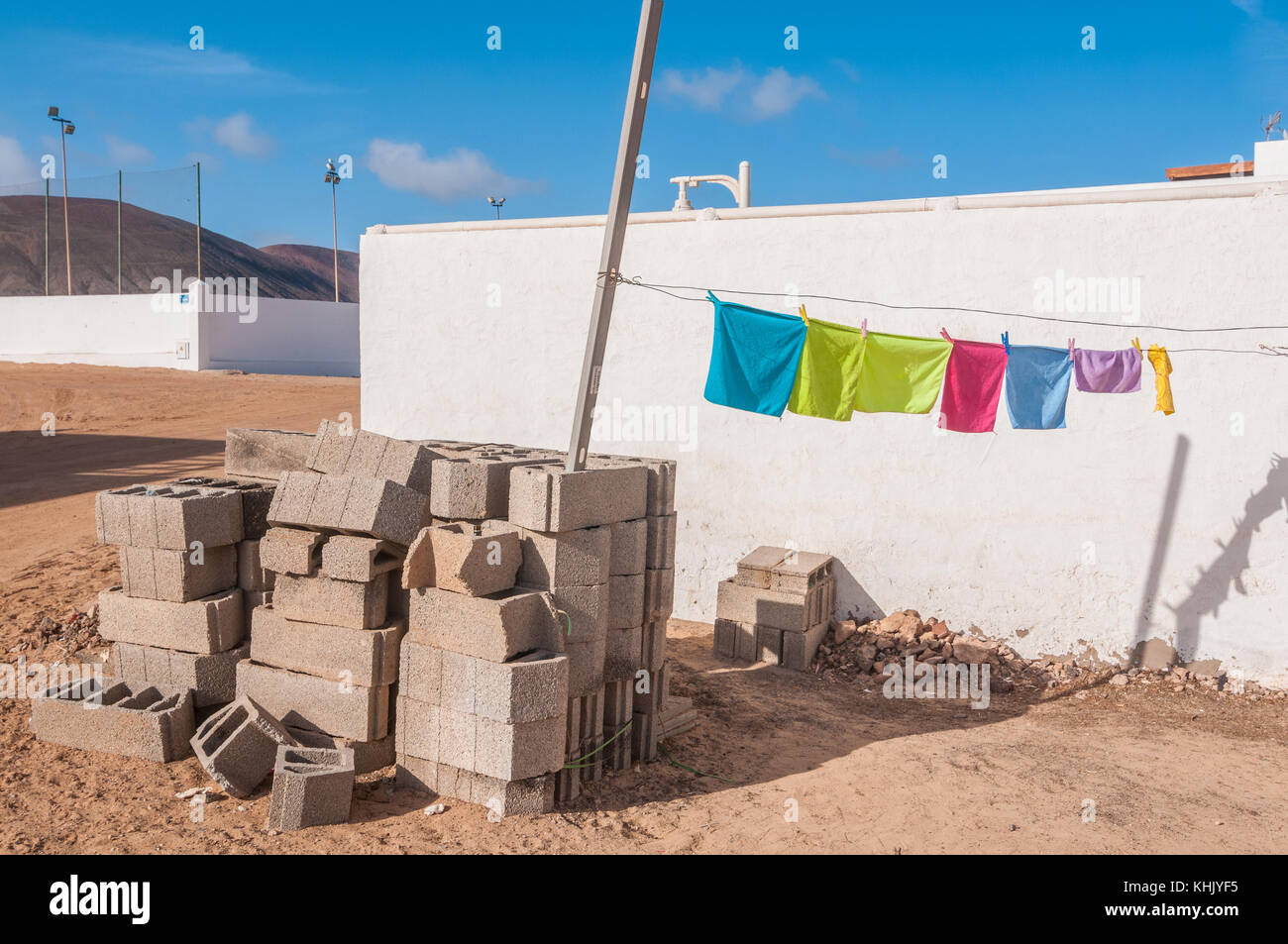 view of a typical street of Caleta del Sebo with color clthes hanging ...