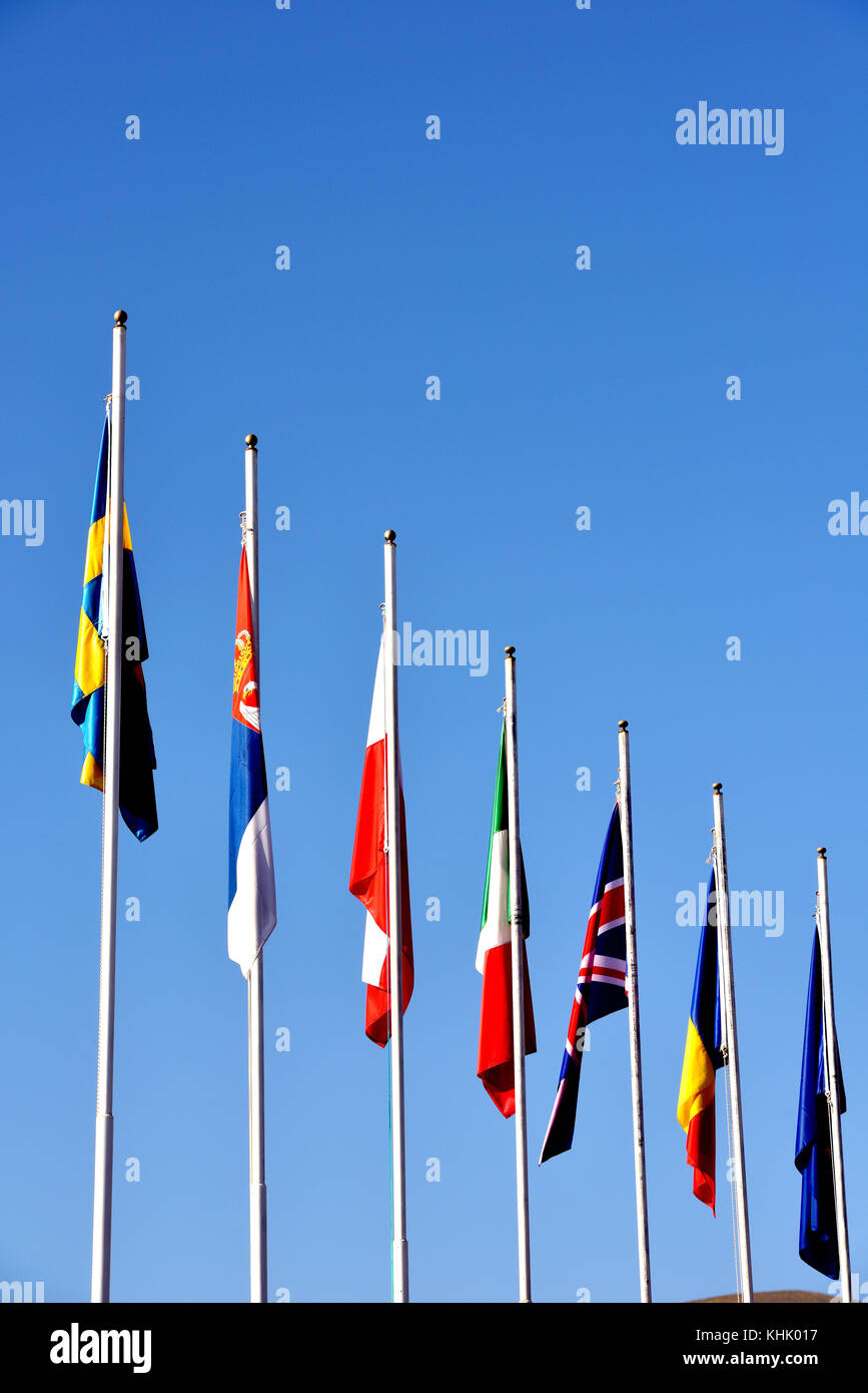 the flags of the European nations on flagpoles in various colours ...