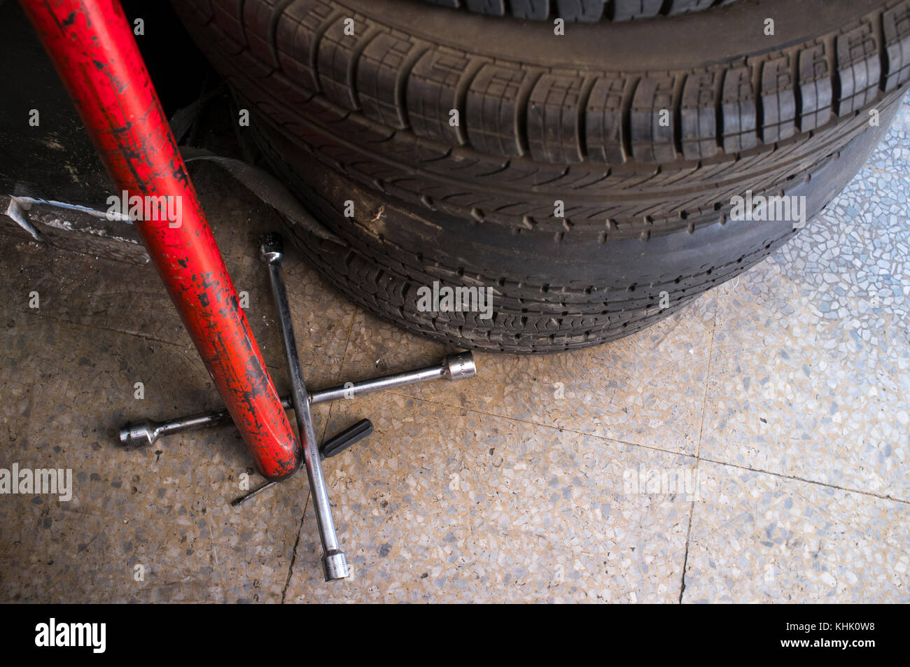 Used tyres with Fixed Cross Wheel Wrench. Changing car tire concept ...