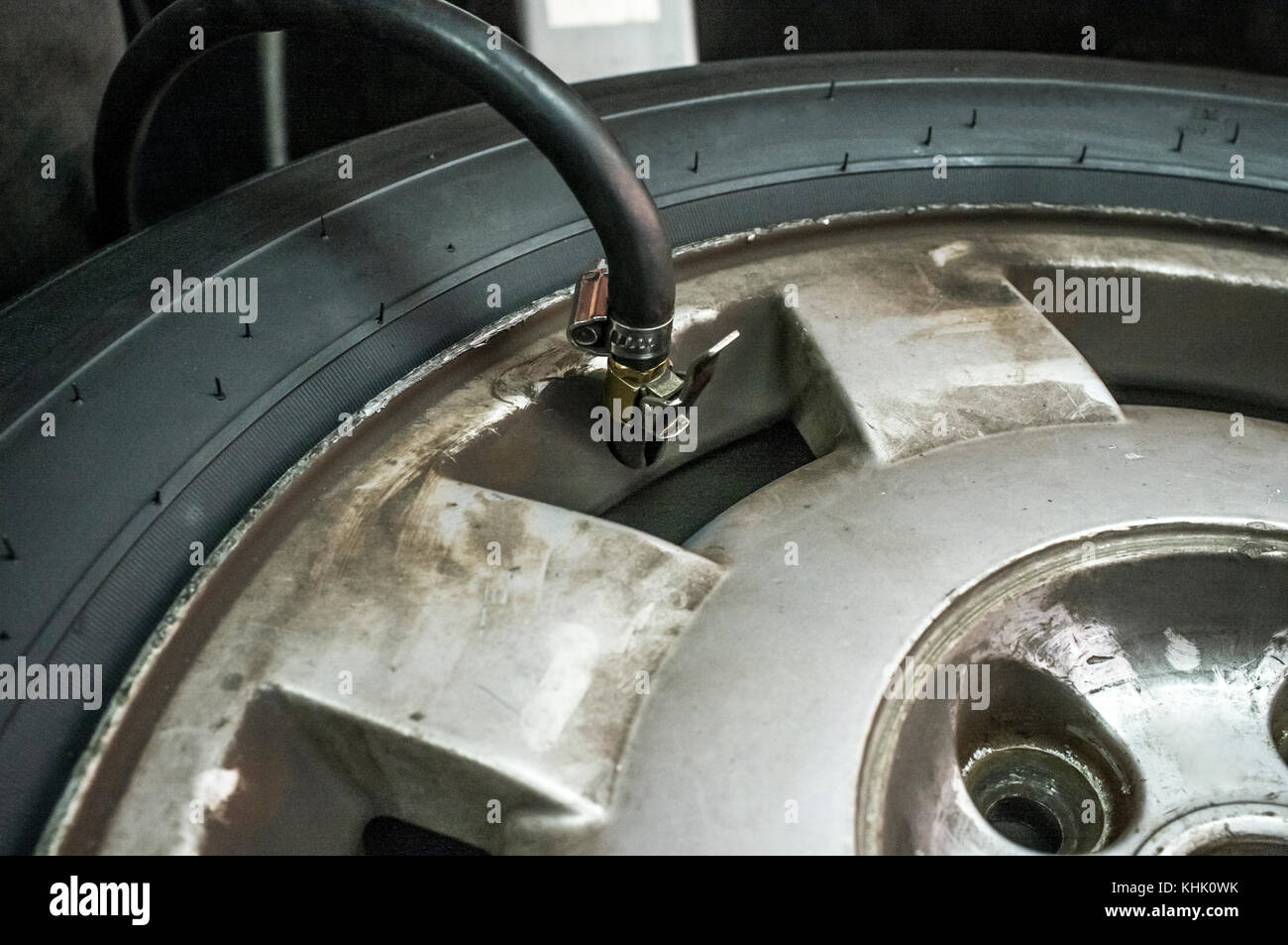 Inflating the tyre in the motor vehicle workshop. Installing wheel ...