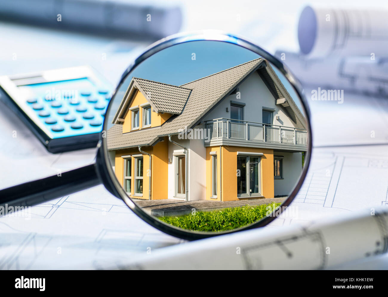 Modern family home under a magnifying glass Stock Photo - Alamy