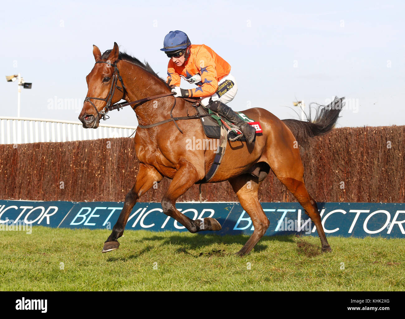 What A Moment ridden by Richard Harding clears the last fence before ...