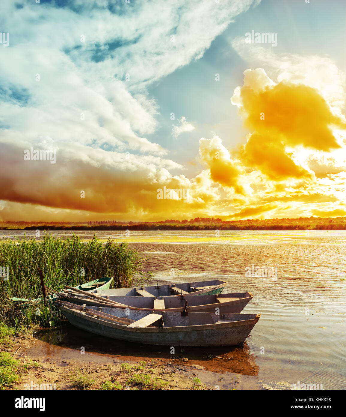 colored sunset over river with boats Stock Photo - Alamy