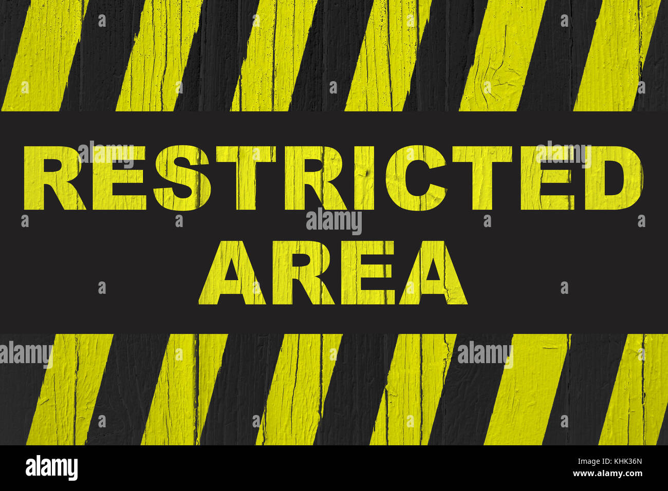 Restricted area warning sign with yellow and black stripes painted over ...