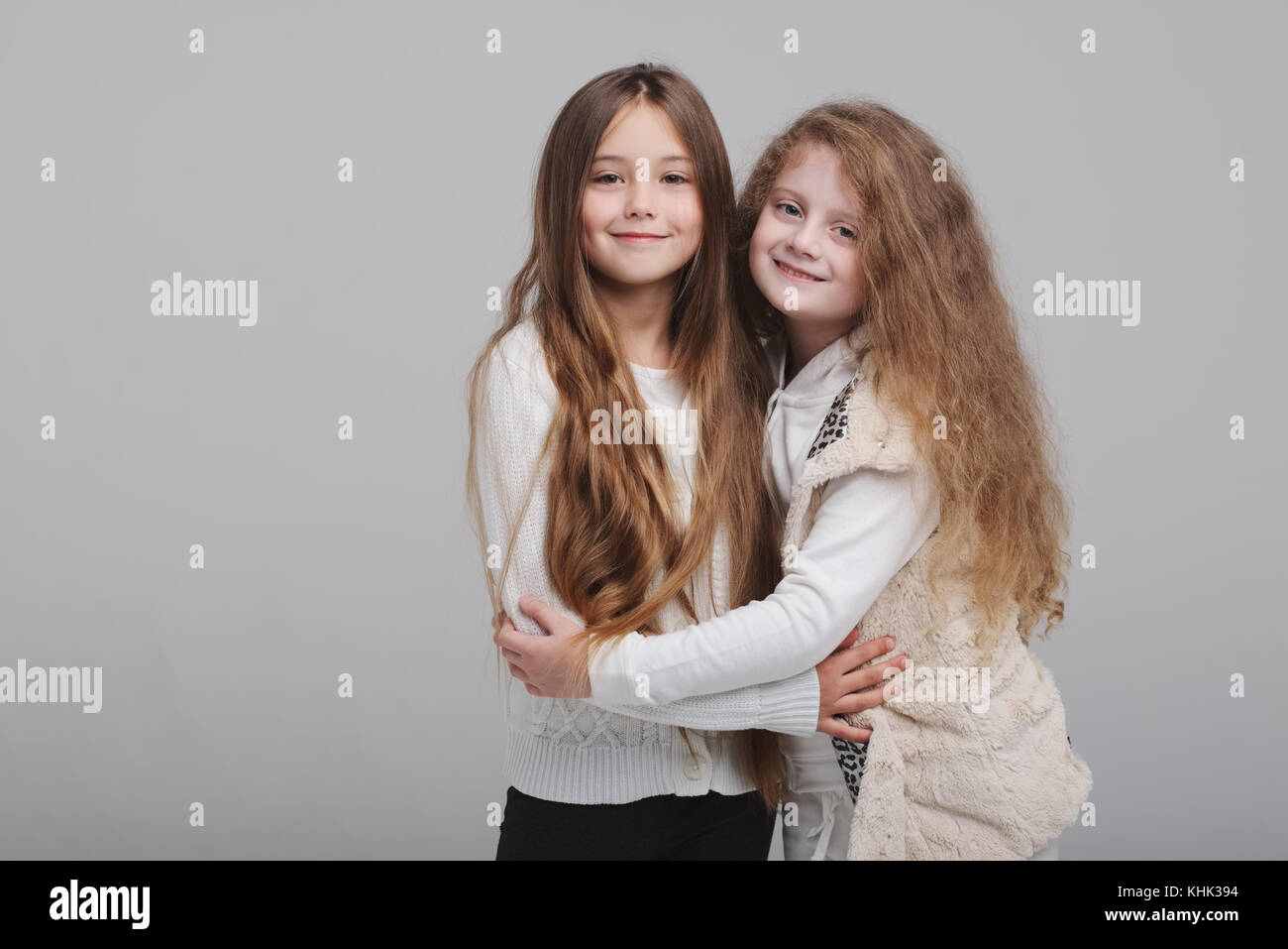 portrait of two beautiful girls on white background Stock Photo - Alamy