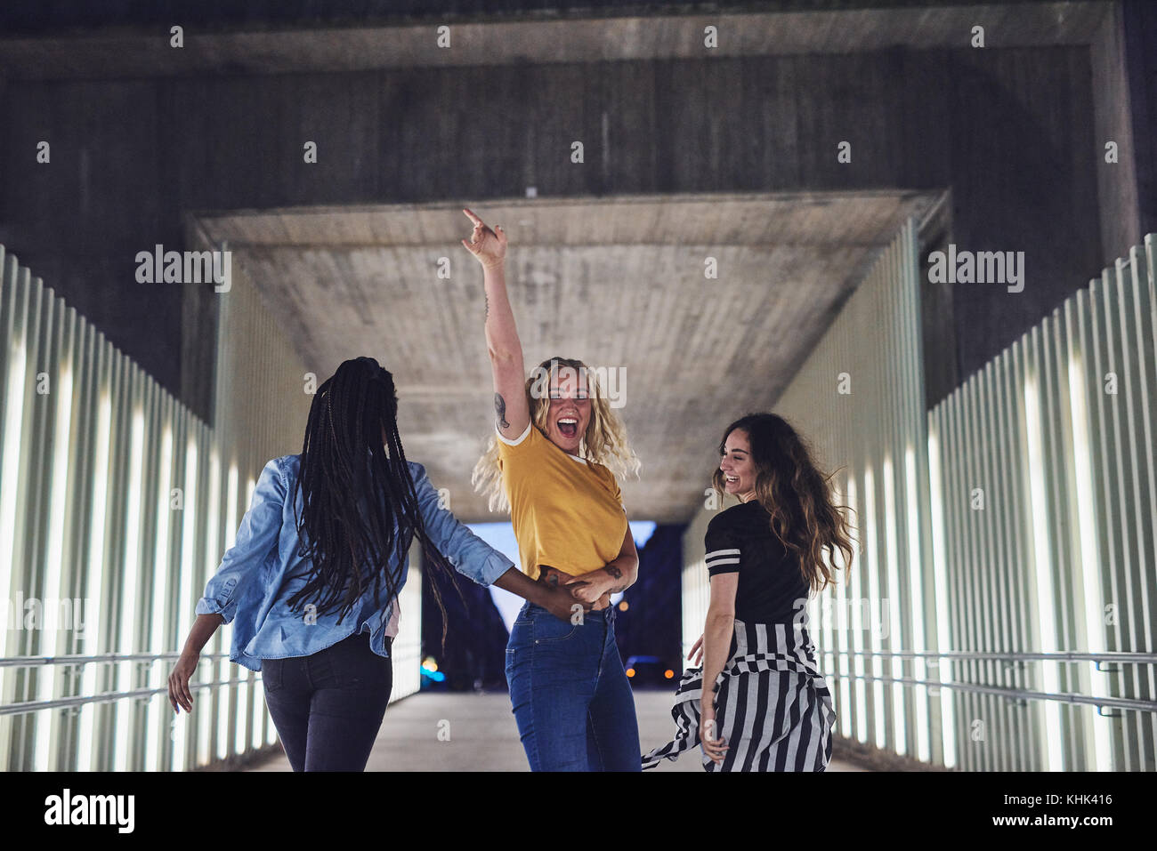 Laughing group of diverse young girlfriends having fun while walking ...
