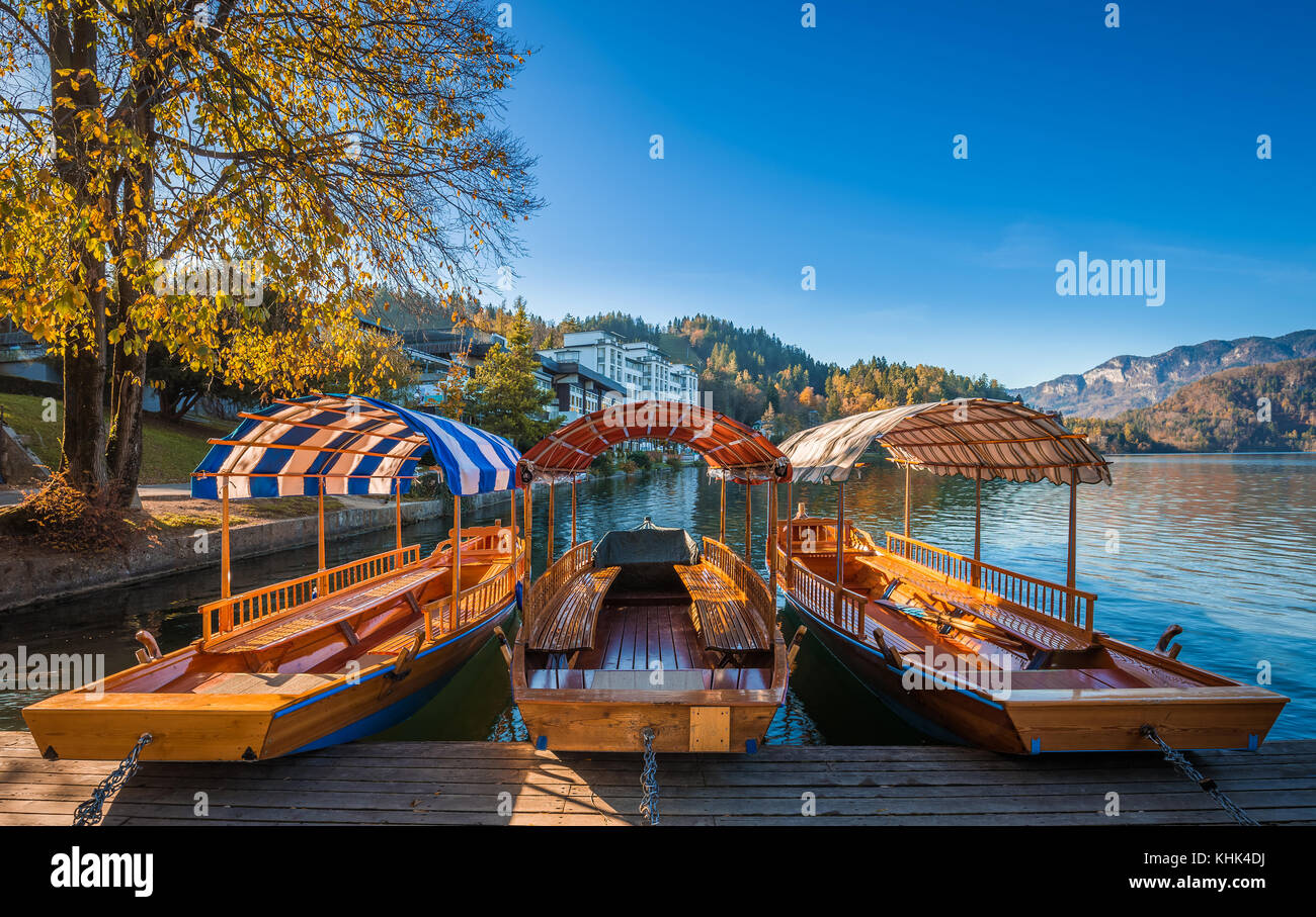 Bled, Slovenia - Traditional red, orange and blue Pletna boats in the ...
