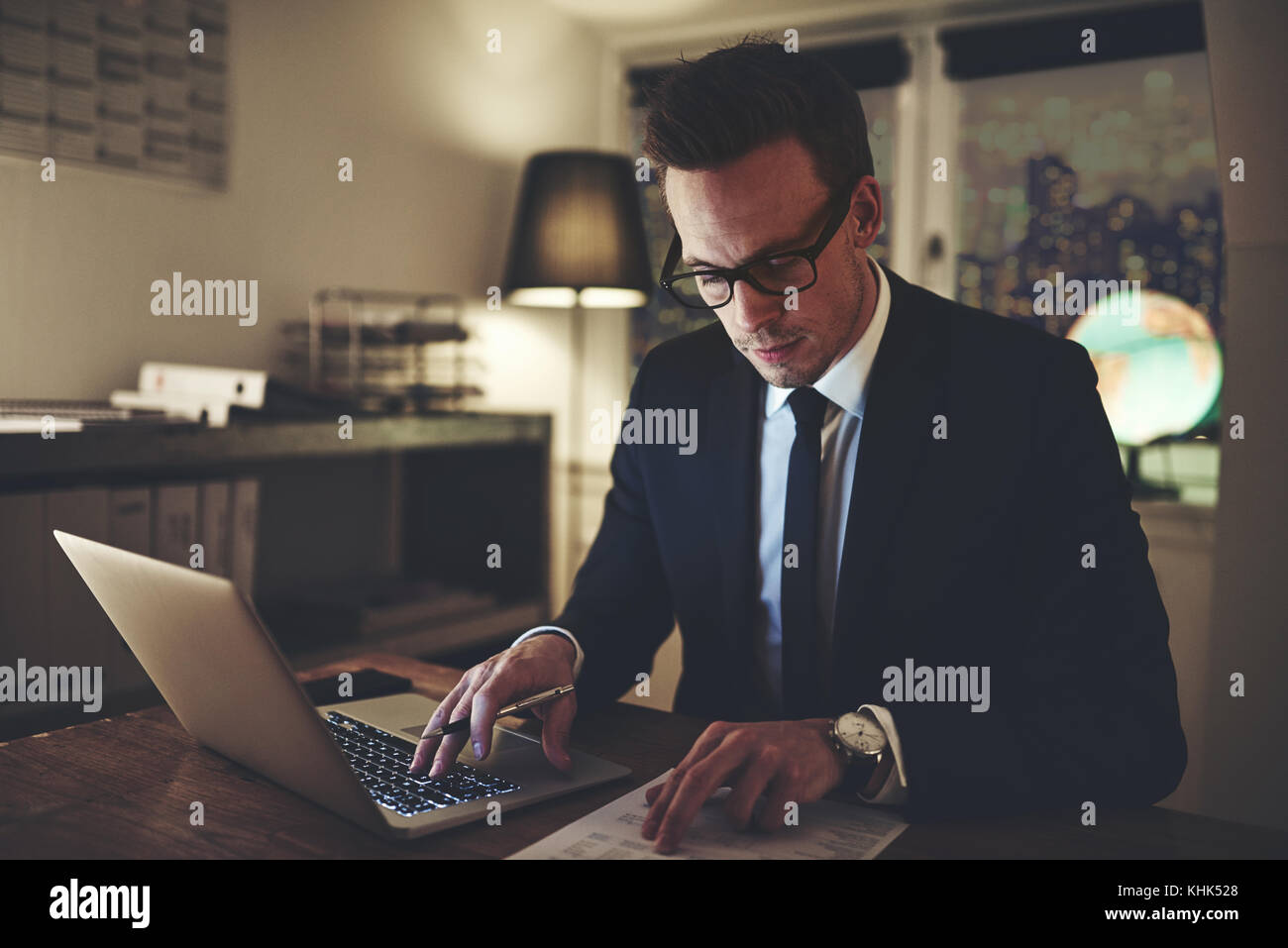 Serious business man working on documents looking concentrated Stock ...