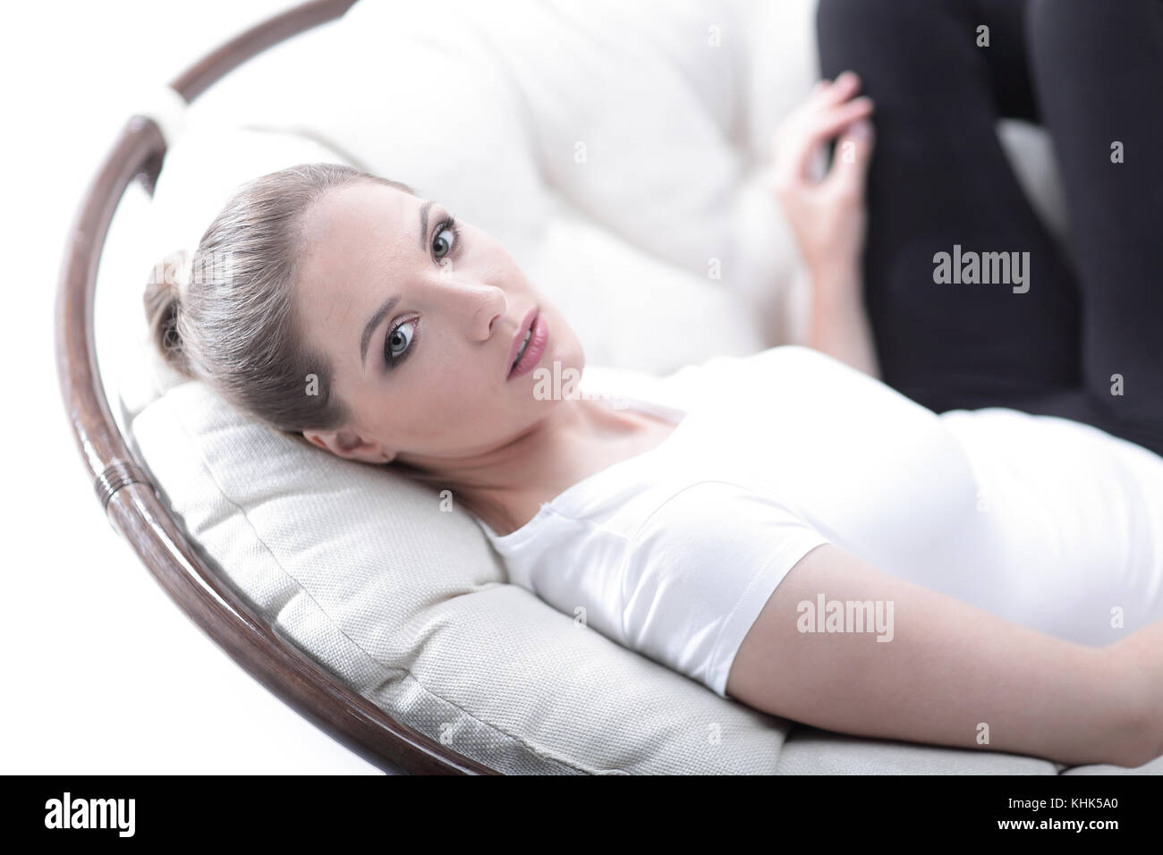 tired woman resting in an easy chair made of rattan Stock Photo - Alamy