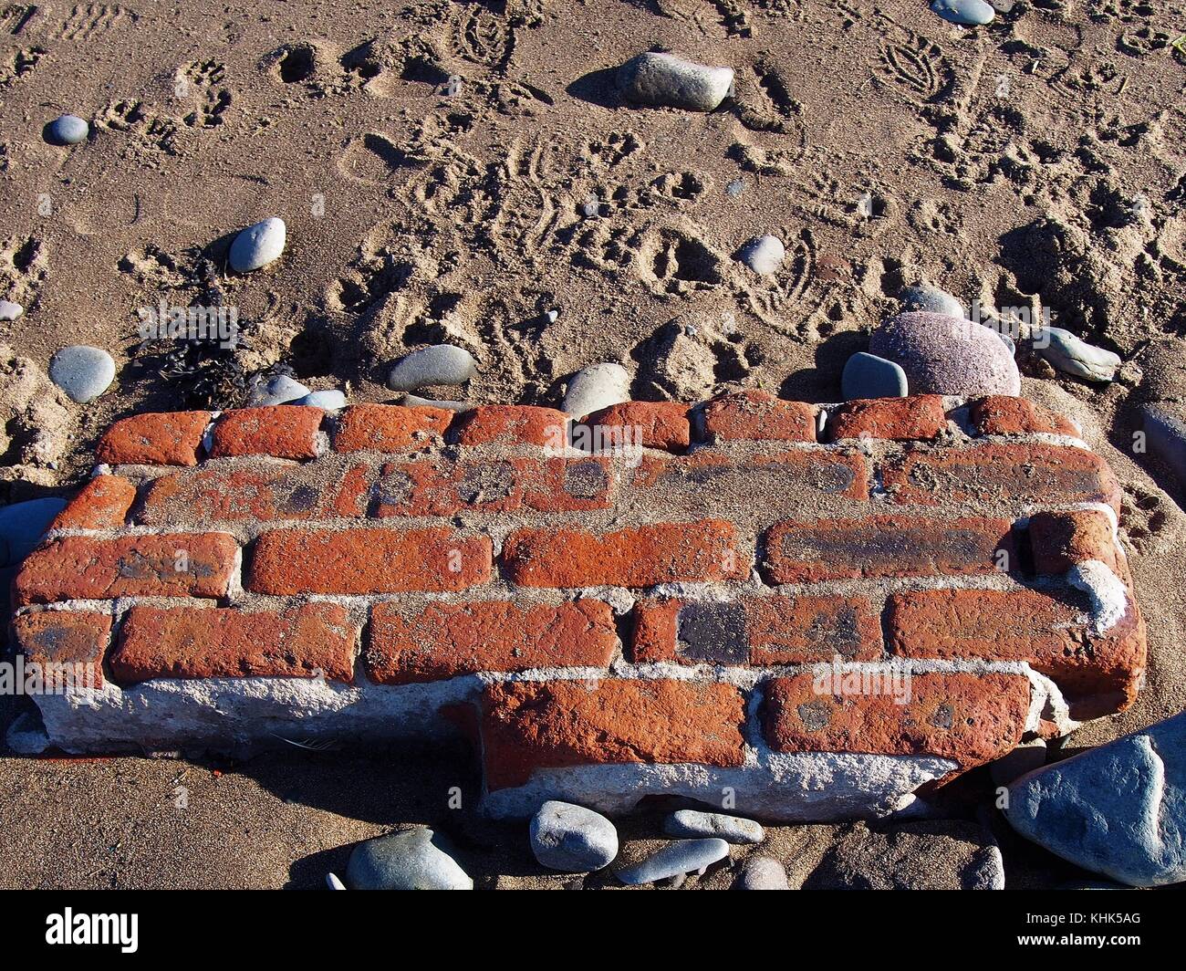 Wave Rounded Brick Wall section lying on Allonby Beach, Cumbria, United ...