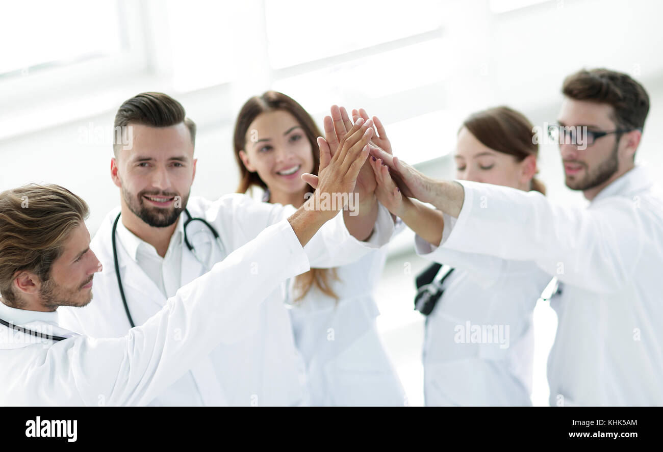 Doctors giving high five team hi-res stock photography and images - Alamy
