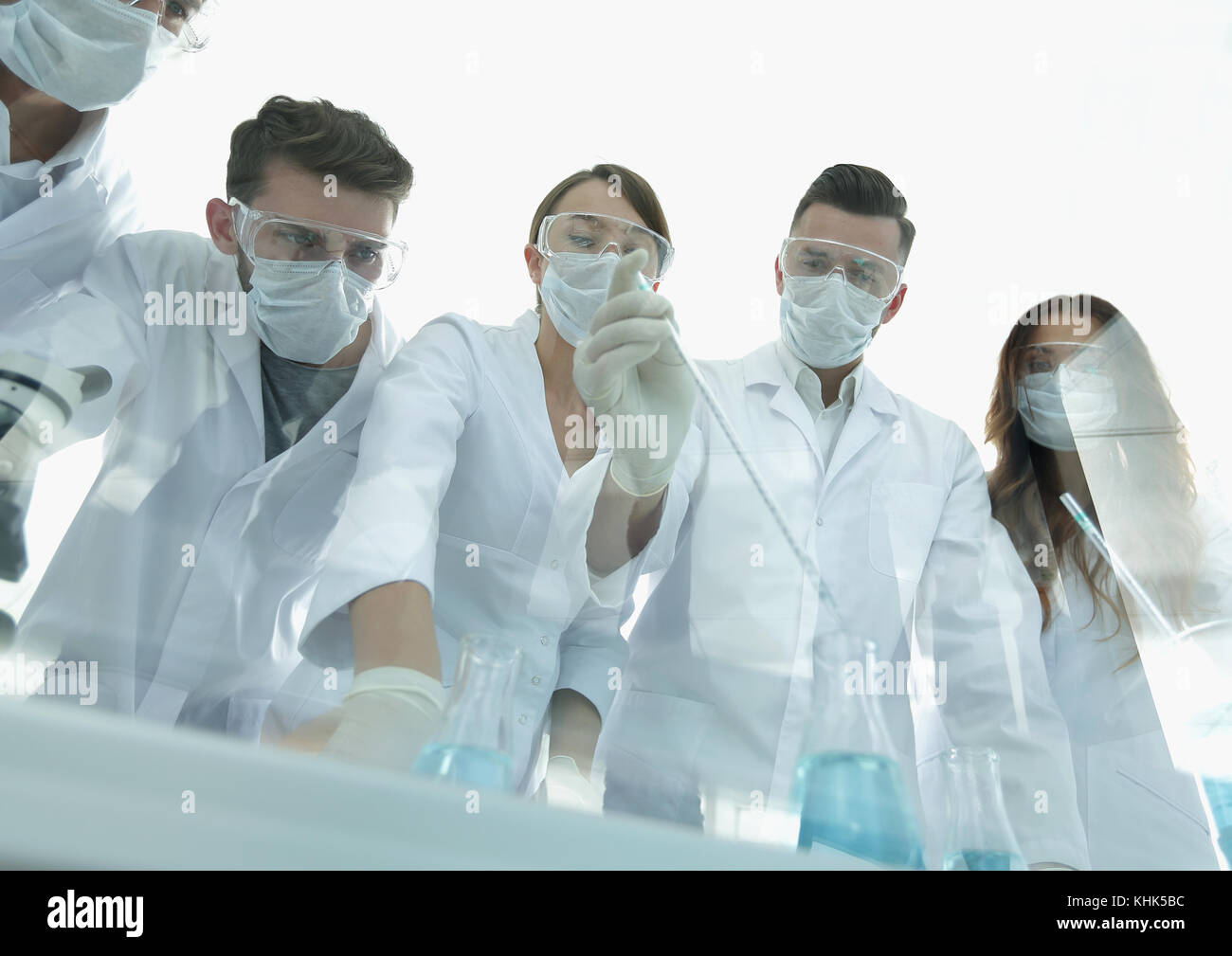 scientists working with test tubes and microscope in the laboratory ...