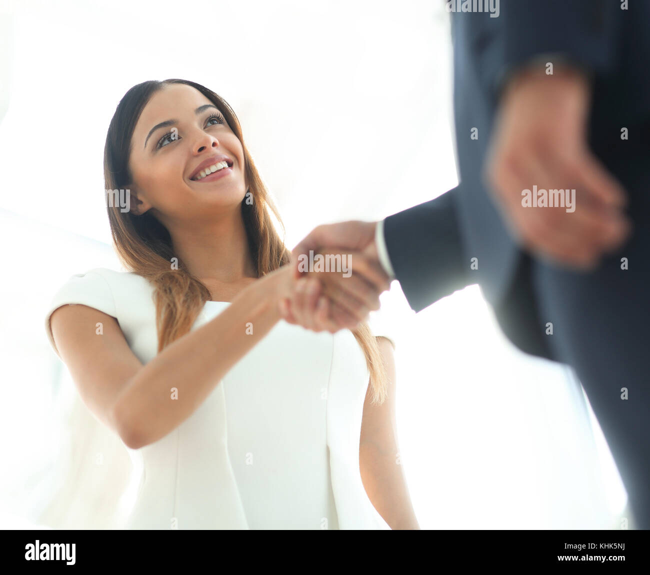 Business woman shaking hand to her partner Stock Photo - Alamy