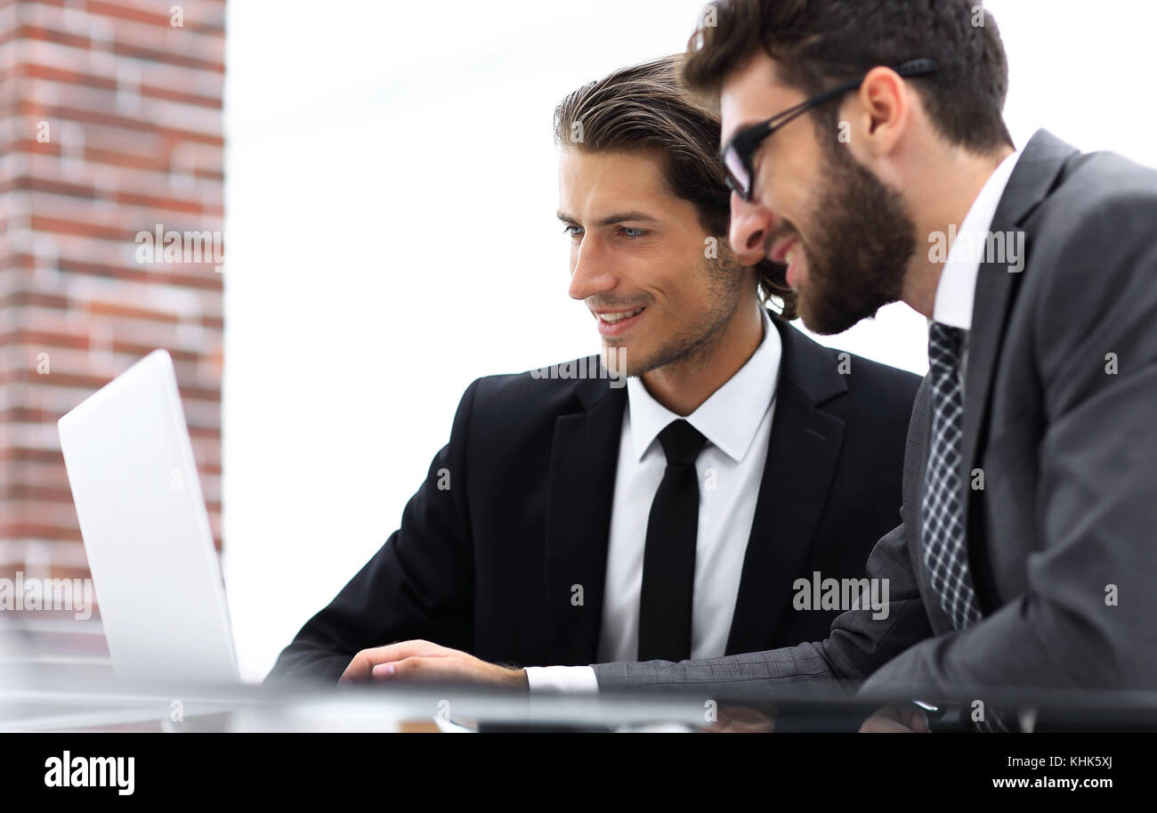 Male executives in office, looking at computer Stock Photo - Alamy