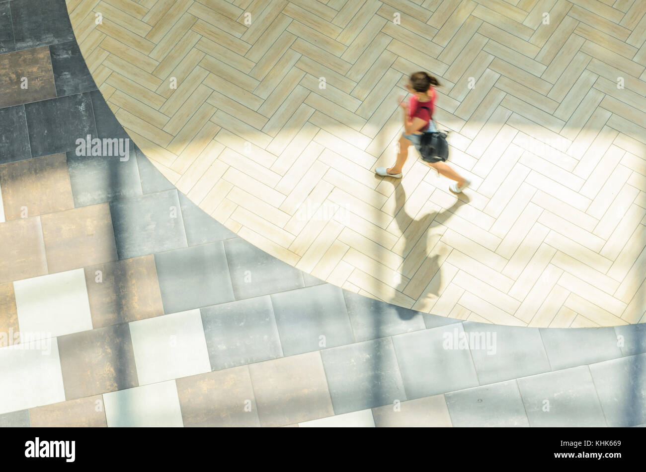 Silhouette of a walking woman with long shadow from above. Abstract ...