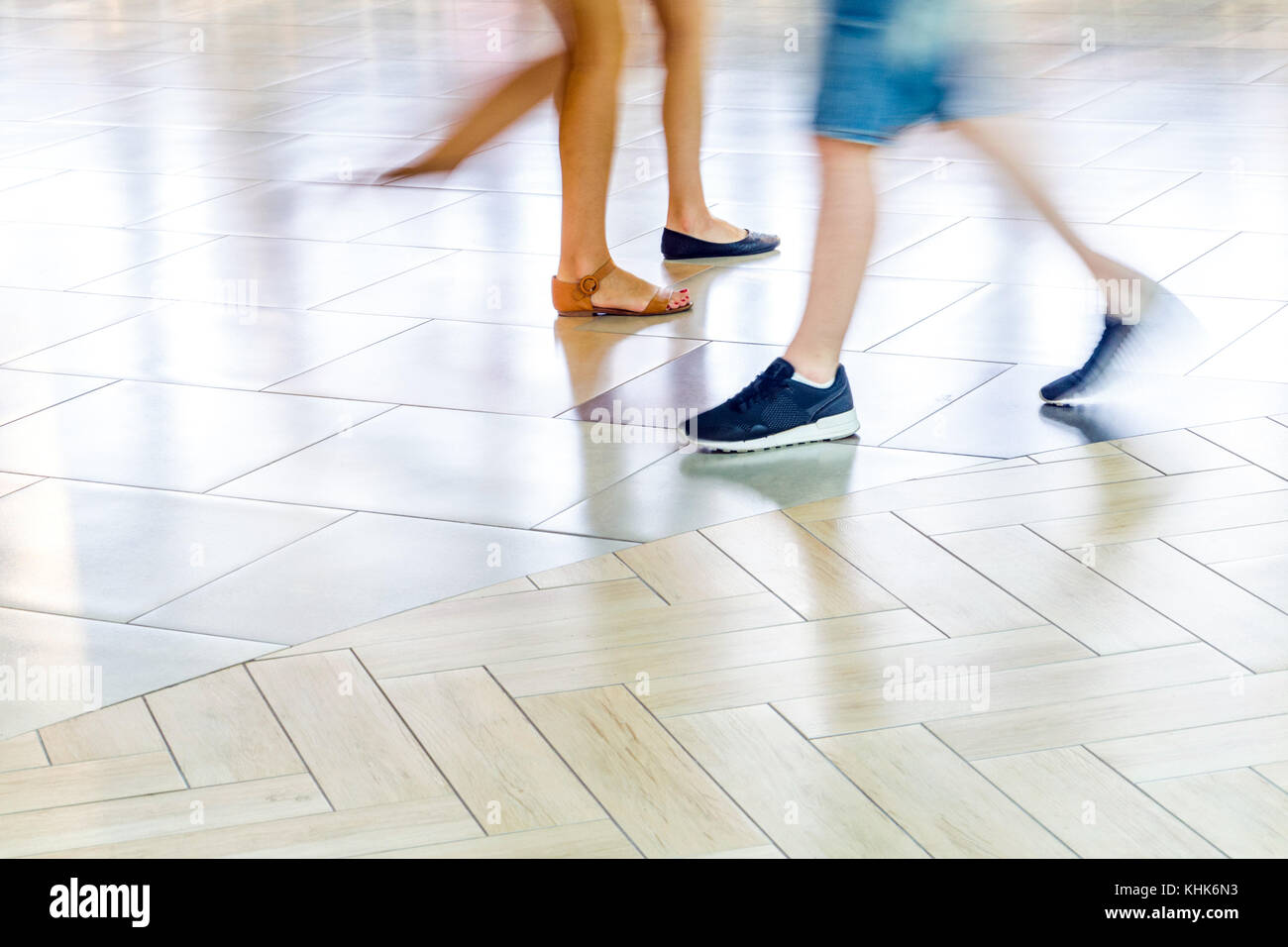People walking on the tiled floor - Detail of legs and shoes moving on ...