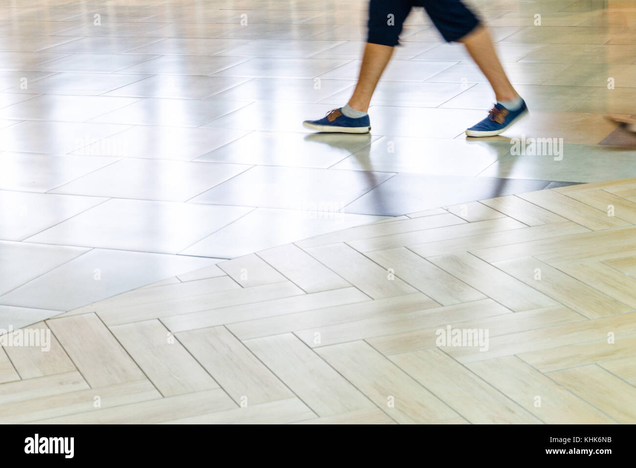 People walking on the tiled floor - Detail of legs and shoes moving on ...