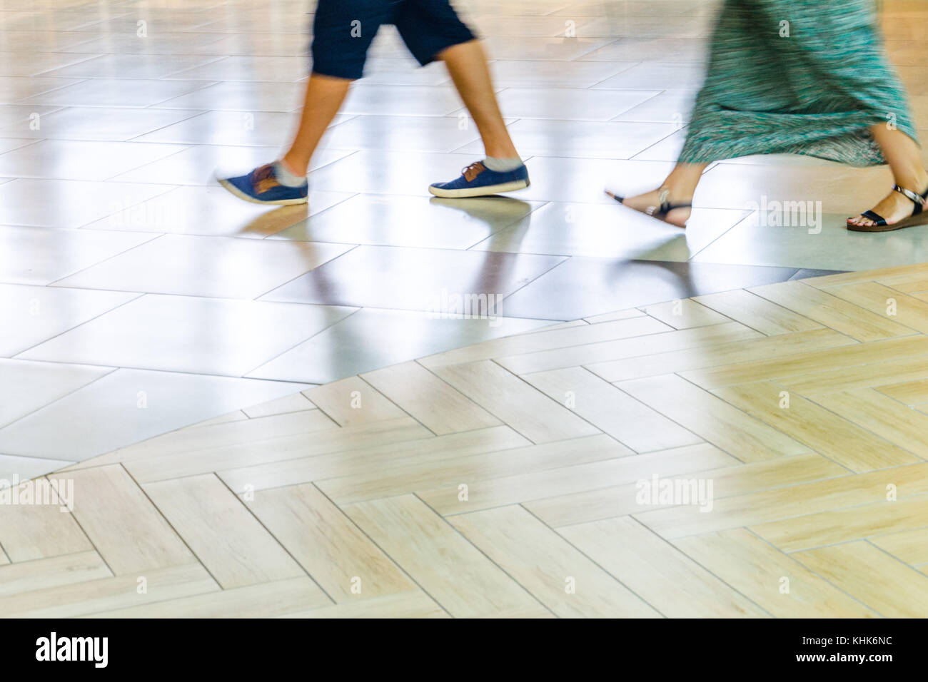 People walking on the tiled floor - Detail of legs and shoes moving on ...