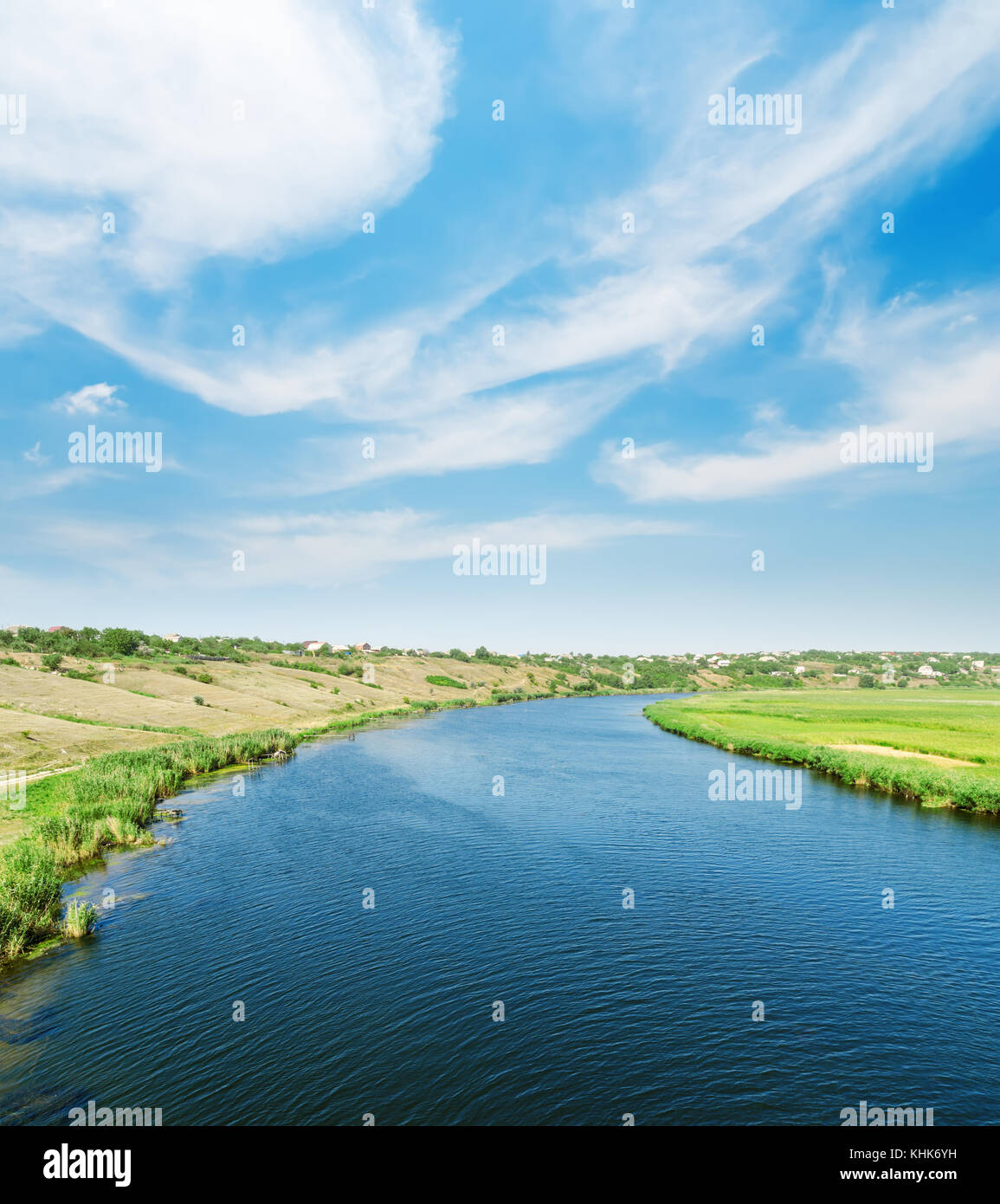 blue river and blue sky with clouds over it Stock Photo - Alamy