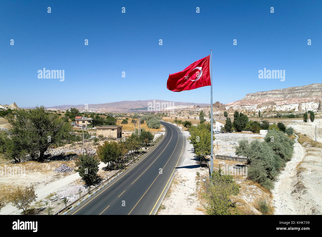 A large Turkish flag over the road to Cappadocia. Aerial photography ...