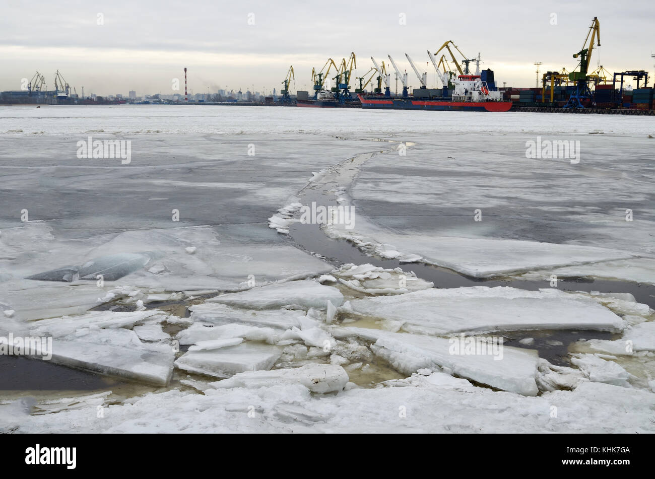 Snowy winter is in port.The river is covered in thick ice Stock Photo ...