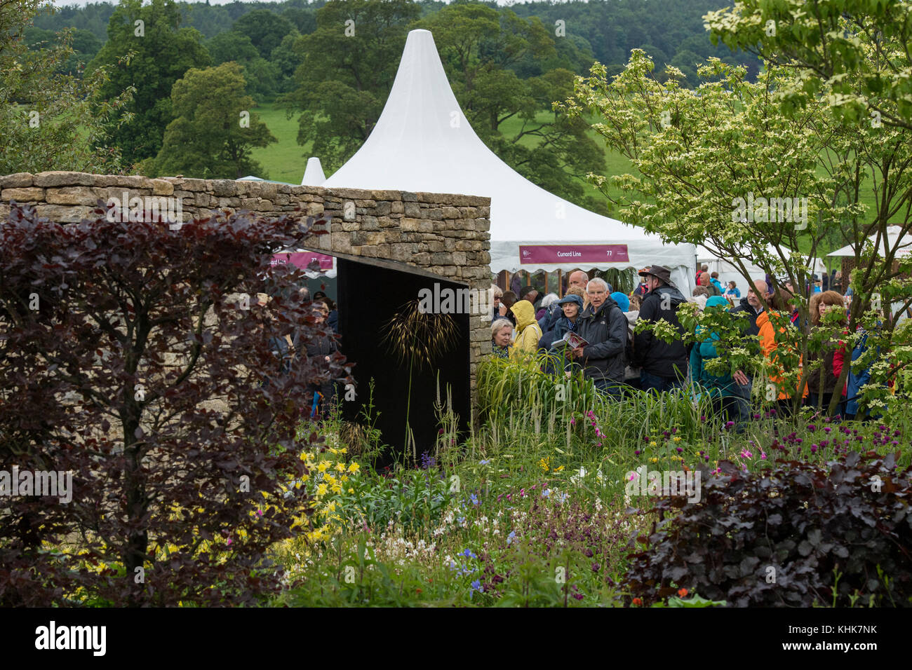 Walls shelter quiet, secluded area with plants in country style garden ...