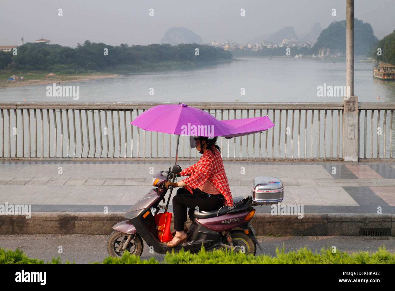 Woman riding a scooter hi-res stock photography and images - Alamy
