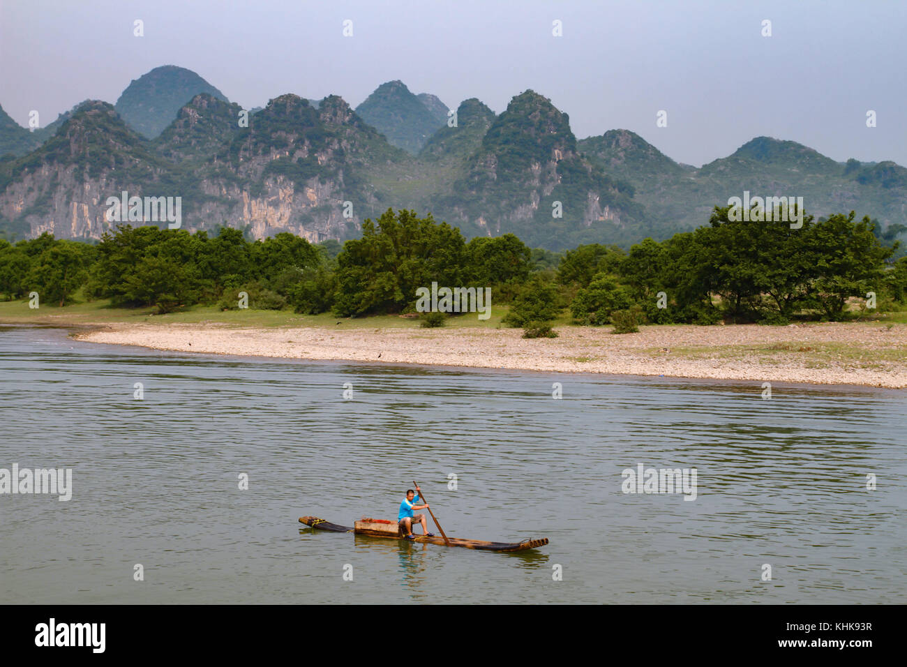 A fisherman rowing a bamboo raft in Guilin, China Stock Photo - Alamy