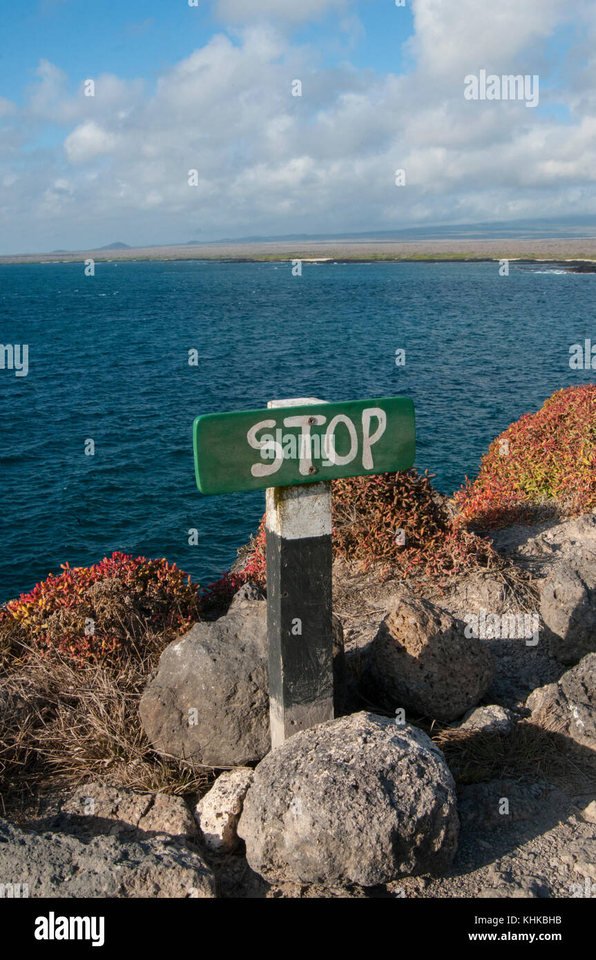 Sign warning tourists of coastal cliffs, Galapagos Islands, Ecuador ...