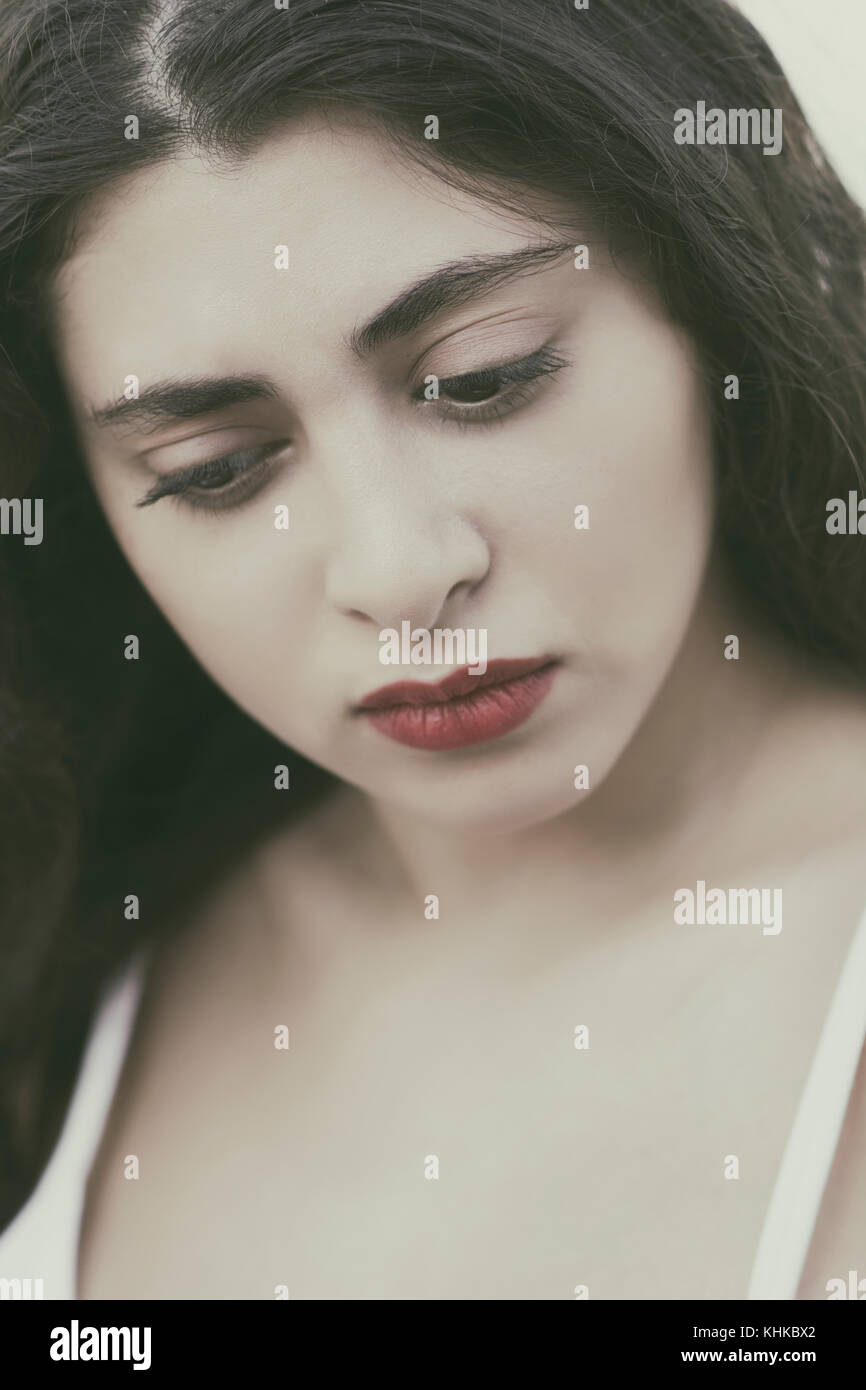 Close up of a sad beautiful woman looking down outdoors Stock Photo - Alamy