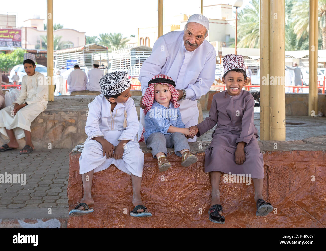Nizwa, Oman, 10th Nobember 2017: omani kid and european kid shaking ...