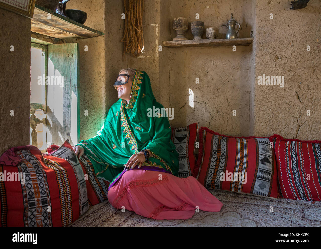 beautiful young lady in traditional omai outfit in an old Omani house ...