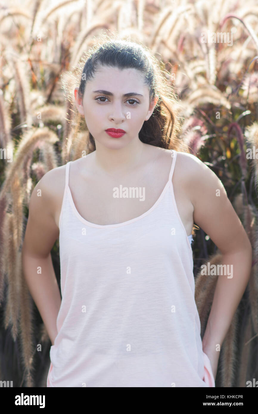 Beautiful young woman staring outdoors Stock Photo - Alamy