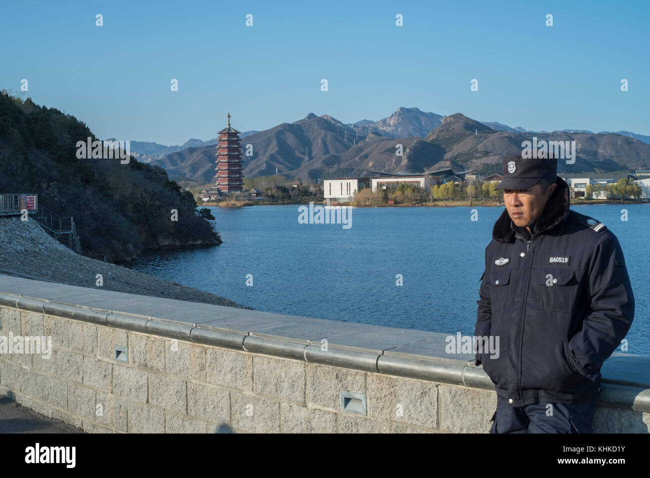 A security guard is on duty along Yanqi Lake in Huairou, Beijing, China ...