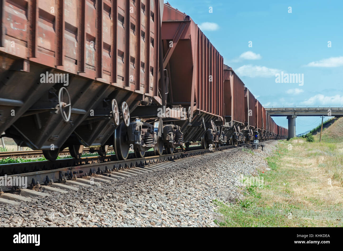 wagons of a freight train in motion go to horizon under bridge Stock ...